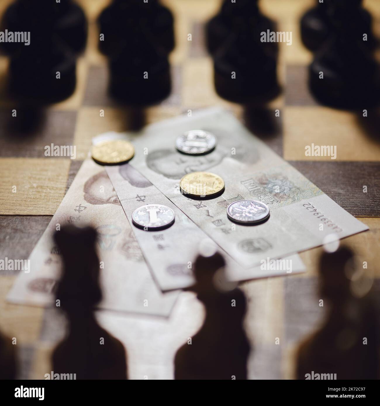 Chinese yuan money on the background of a chess board. Banknotes and ...