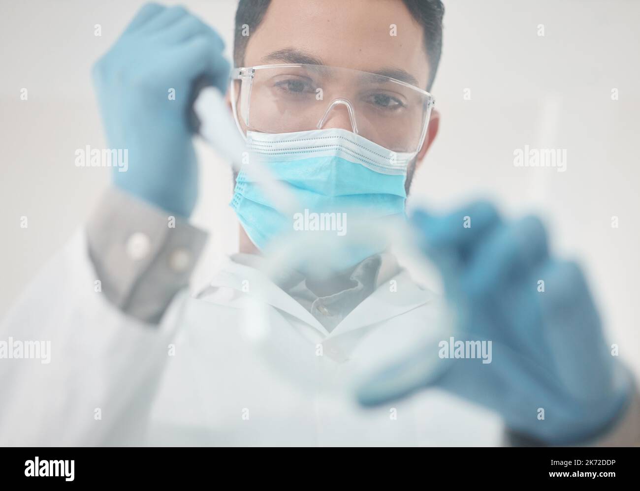 Keeping an eye on the reaction. Low angle shot of a scientist working ...