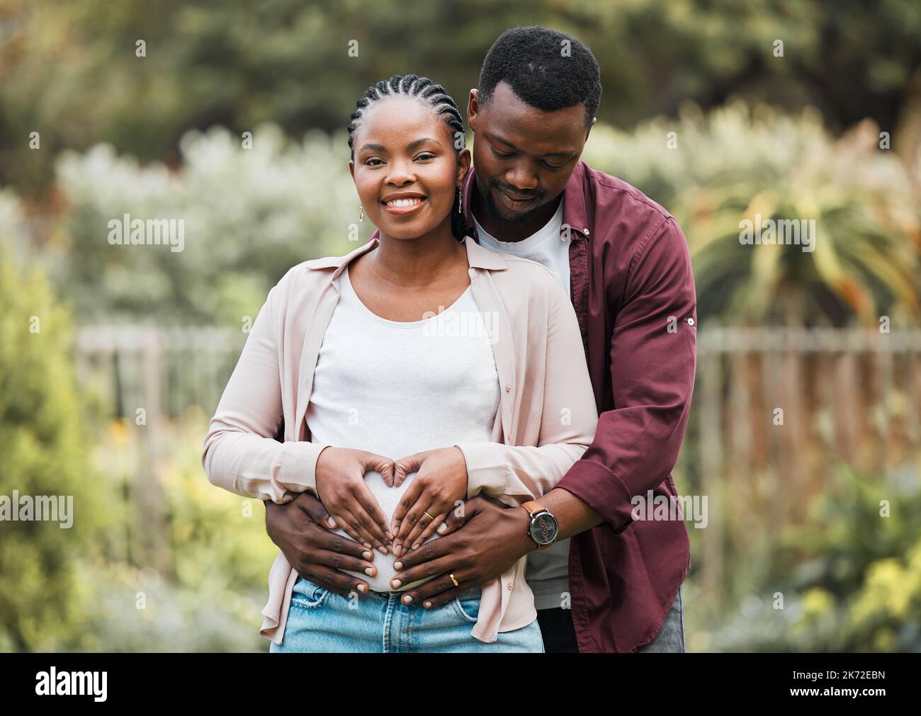 Growing together as a family. a young expecting couple posing together ...