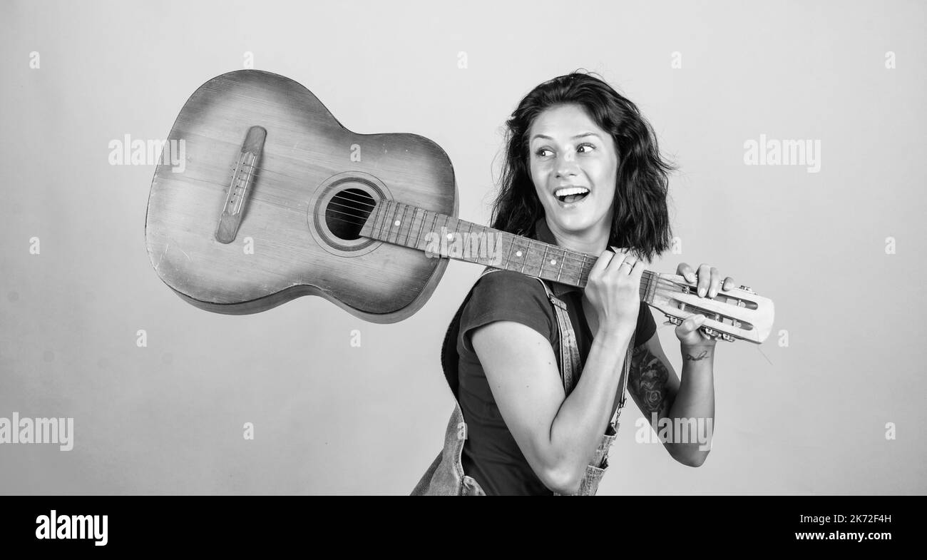 Happy female guitarist playing Black and White Stock Photos & Images ...
