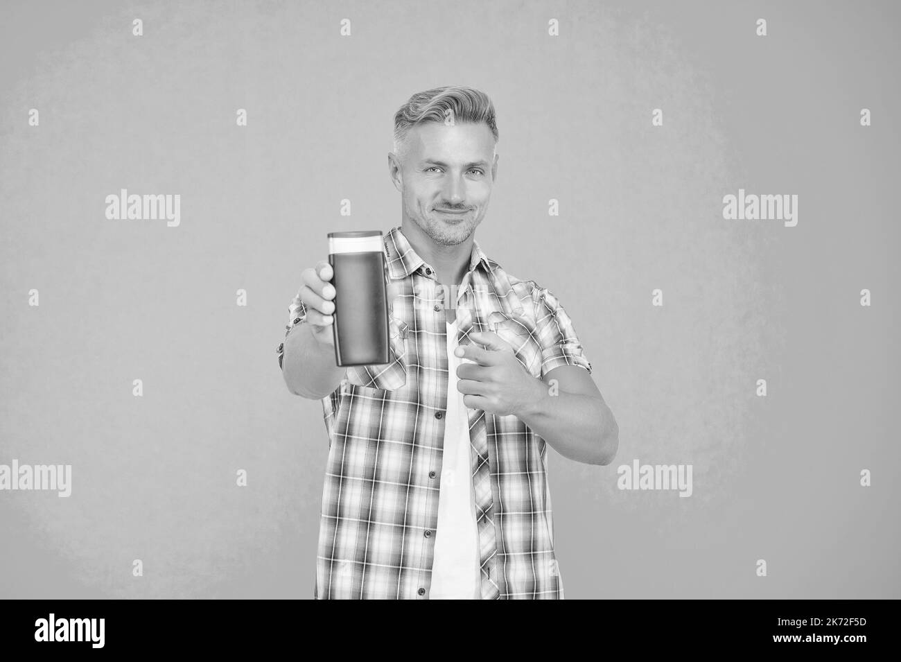 Man point finger at gel bottle blue background. Bath gel. Promoting ...