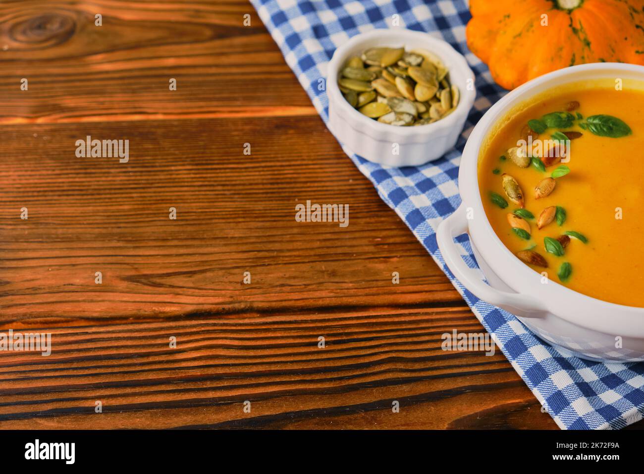 Homemade pumpkin soup with cream, pumpkin seeds and basil Stock Photo ...