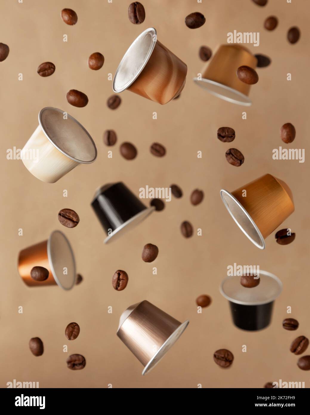 Floating coffee capsules with coffee beans on brown background Stock ...