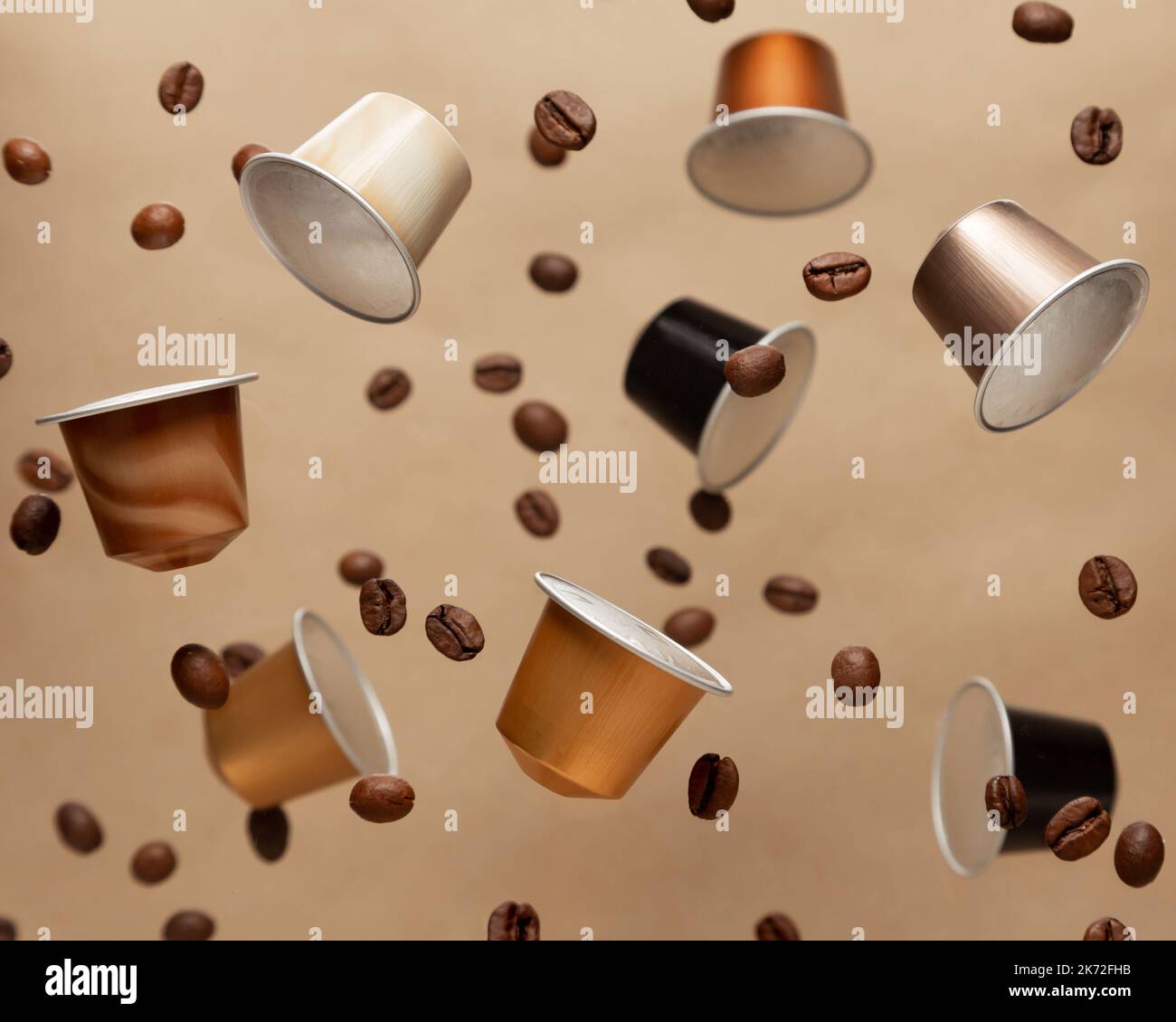 Floating coffee capsules with coffee beans on brown background Stock ...