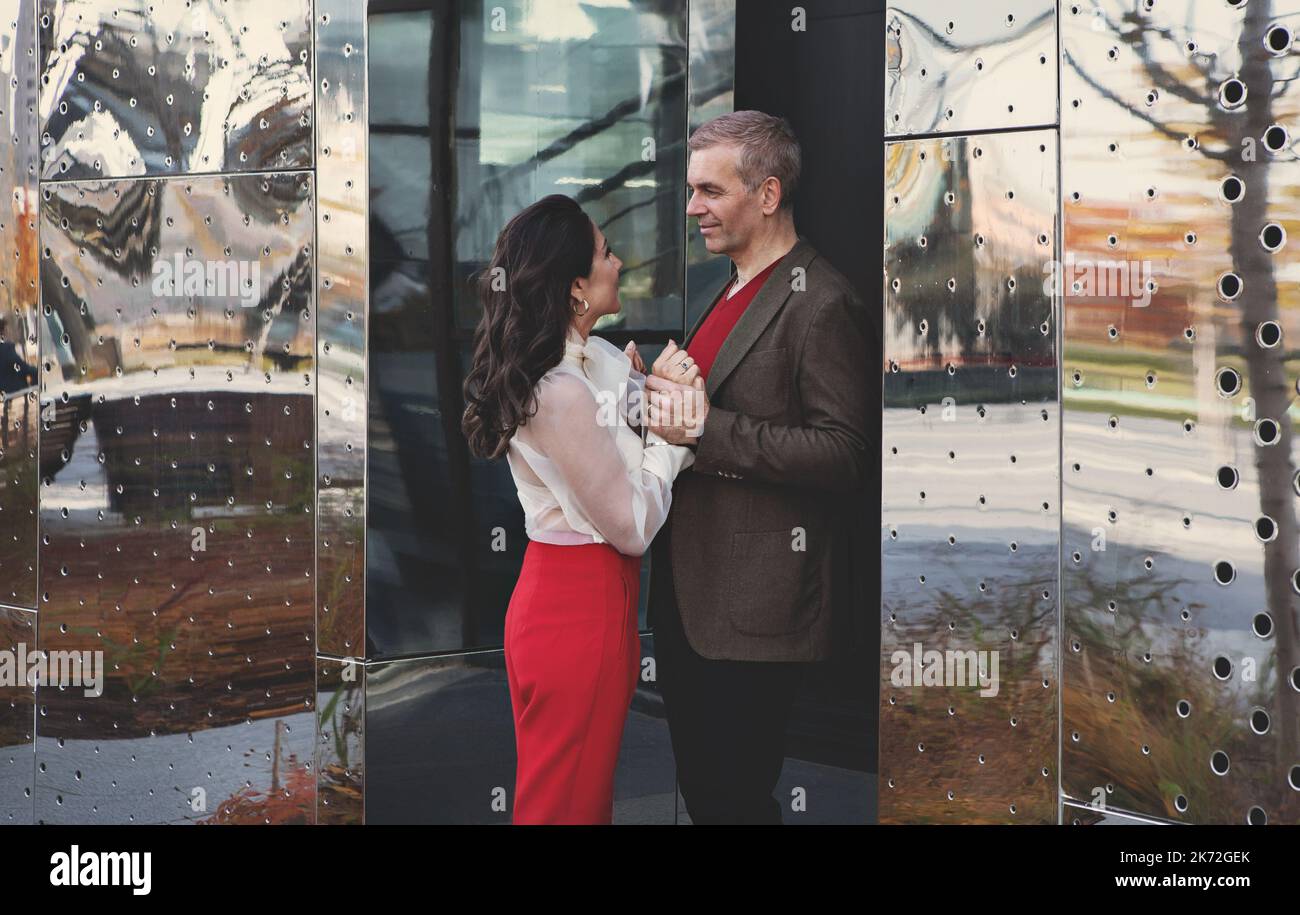 Attractive couple of colleagues talking and flirting near office ...