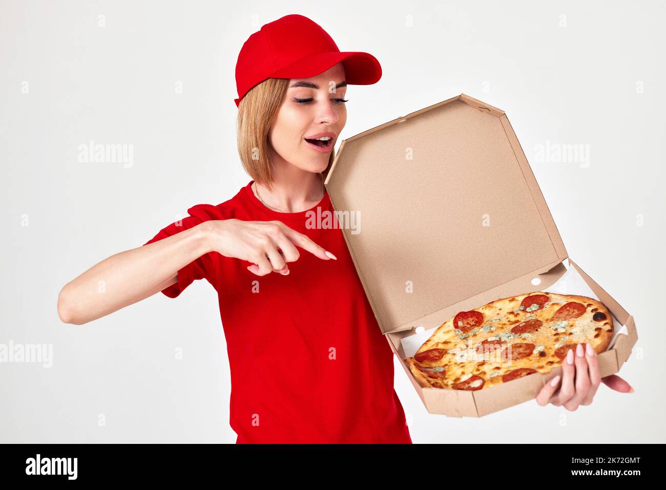pizza delivery girl pointing finger to pizza on white background Stock ...