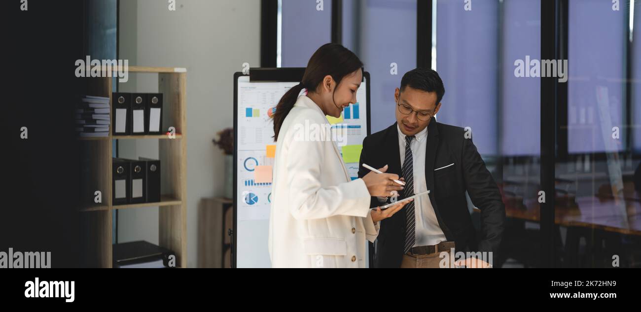 panoramic banner. business people meet and discuss chart and point at ...