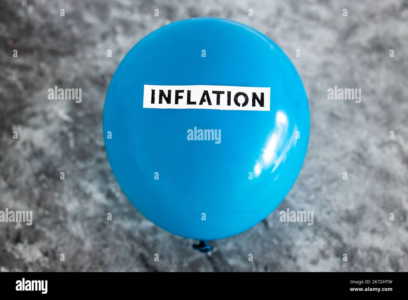 inflation text on top of big inflated balloon, funny conceptual image ...