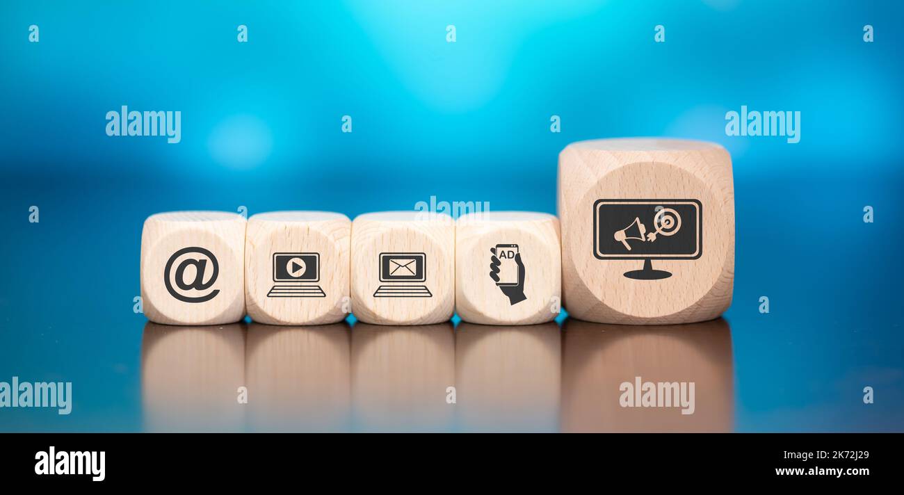 Wooden blocks with symbol of ad targeting concept on blue background ...