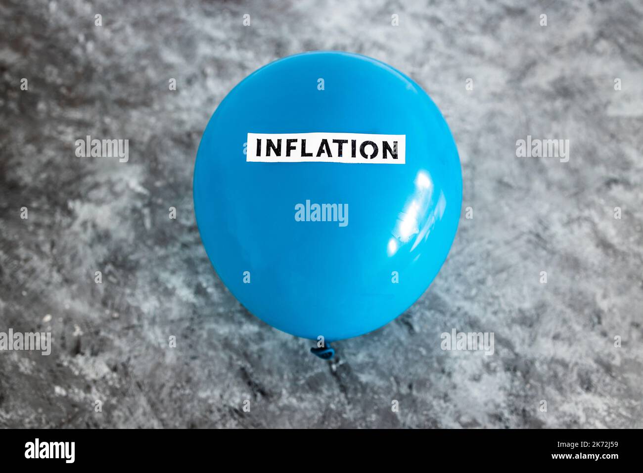 inflation text on top of big inflated balloon, funny conceptual image ...