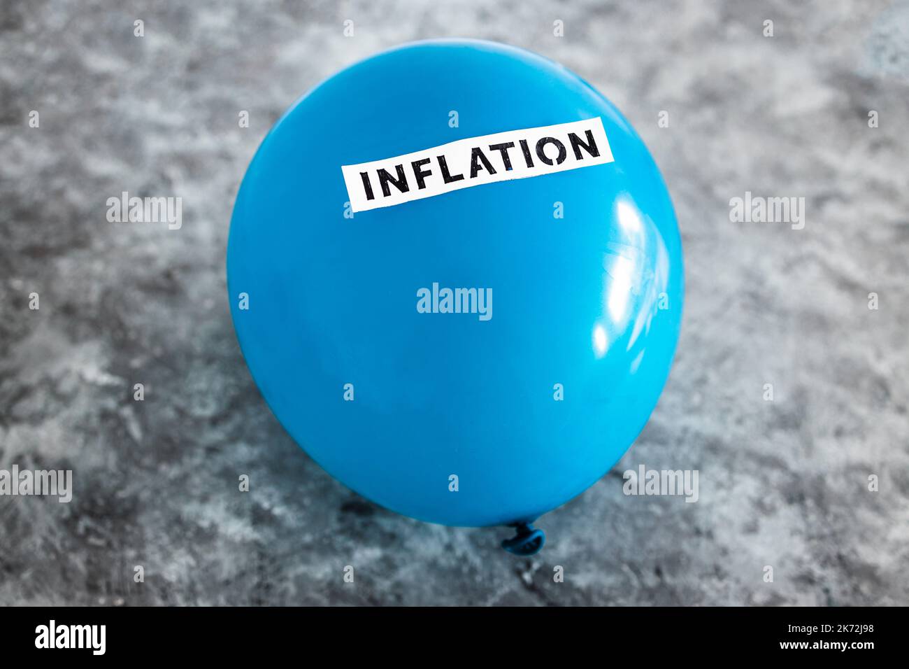 inflation text on top of big inflated balloon, funny conceptual image ...