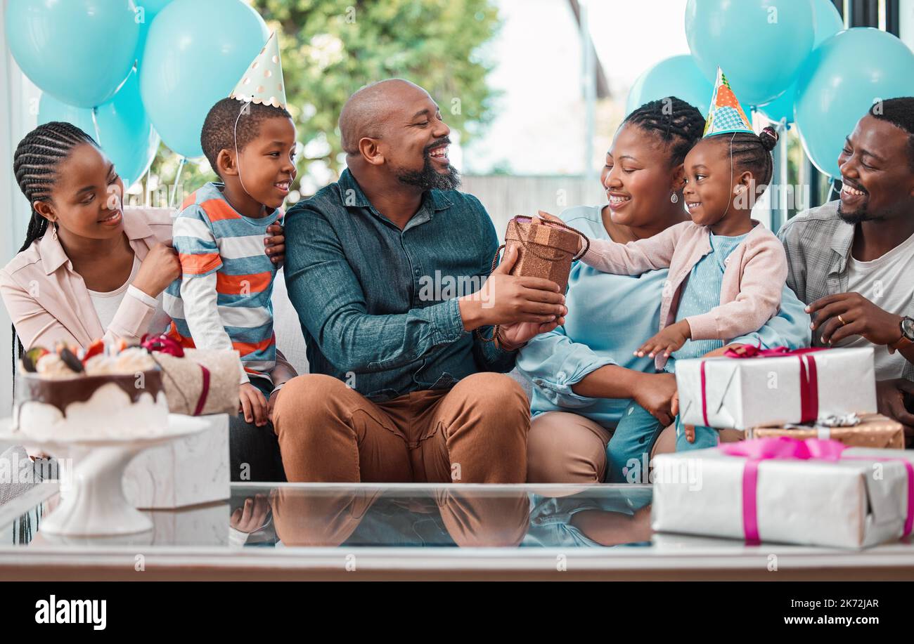 Everyone loves gifts. a family handing over gifts during a birthday ...