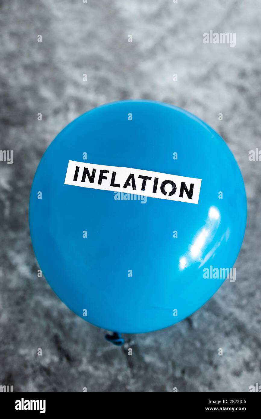 inflation text on top of big inflated balloon, funny conceptual image ...