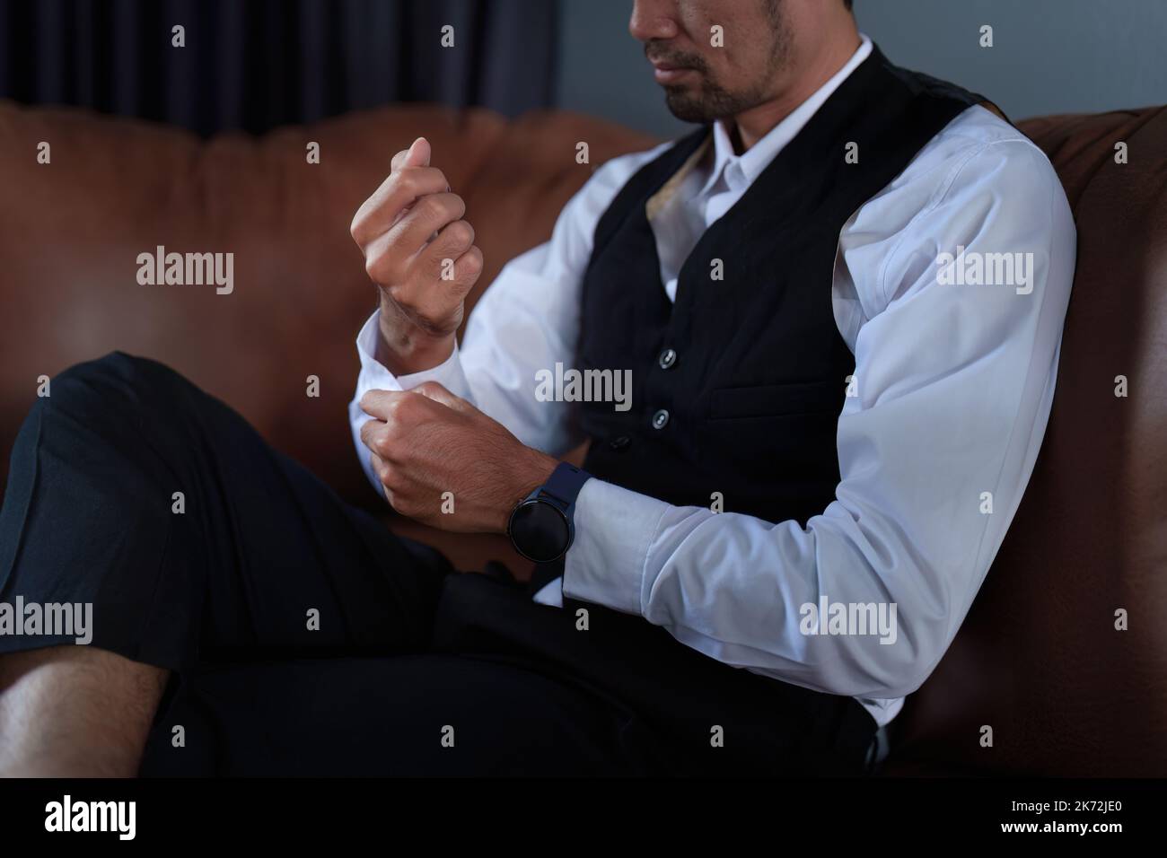 Handsome guy in suit sitting hi-res stock photography and images - Alamy
