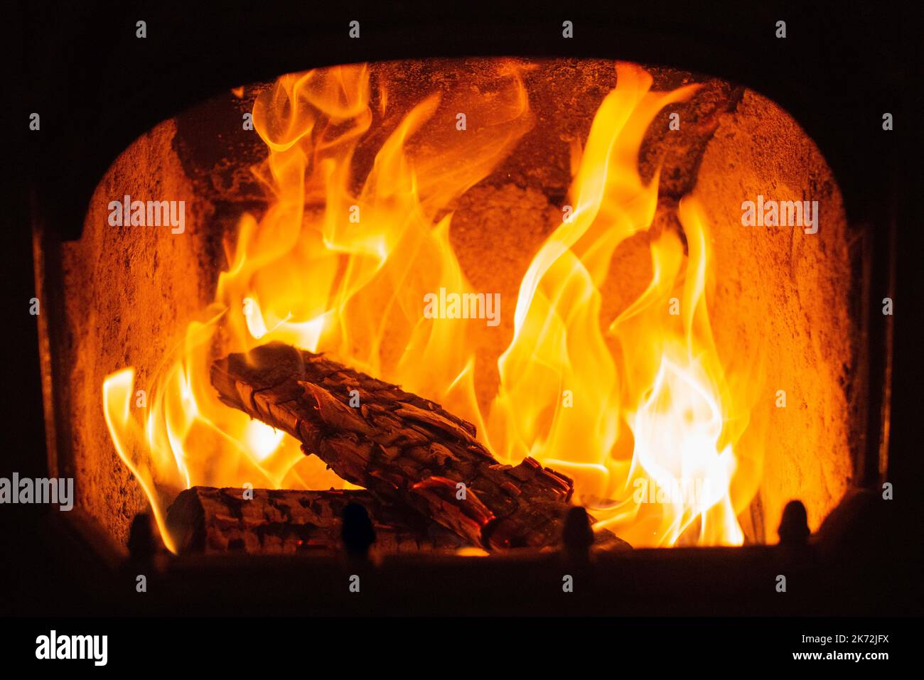 Flame of Wooden logs being burn inside stove Stock Photo - Alamy
