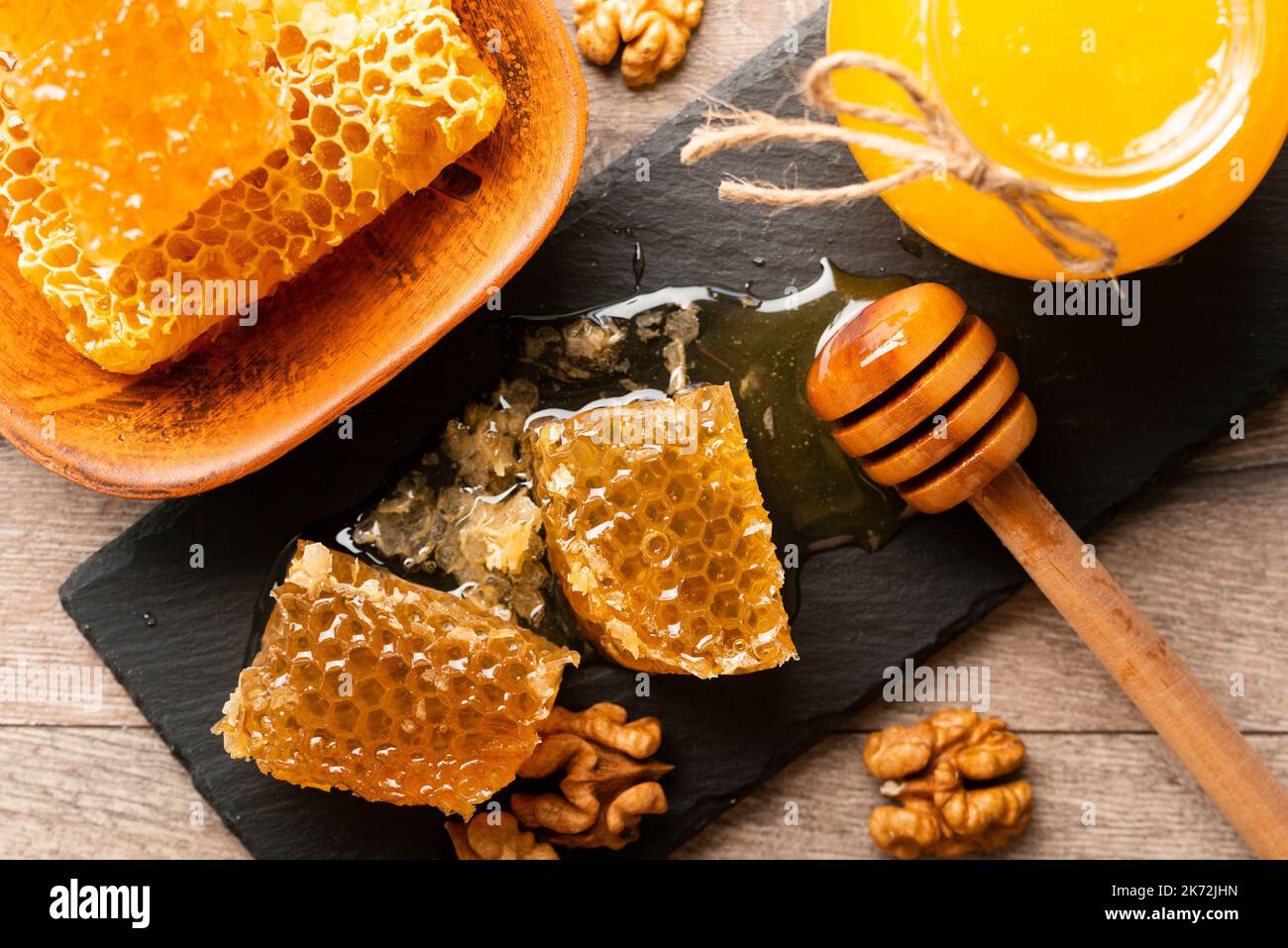 Honeycomb on slate tray with honey and nuts on kitchen table Stock ...