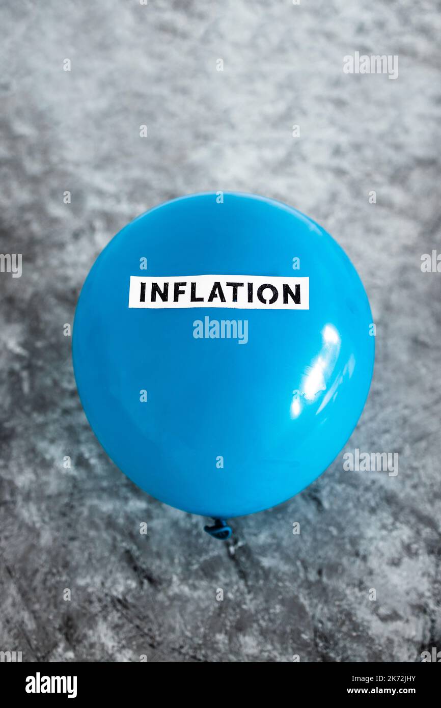 inflation text on top of big inflated balloon, funny conceptual image ...
