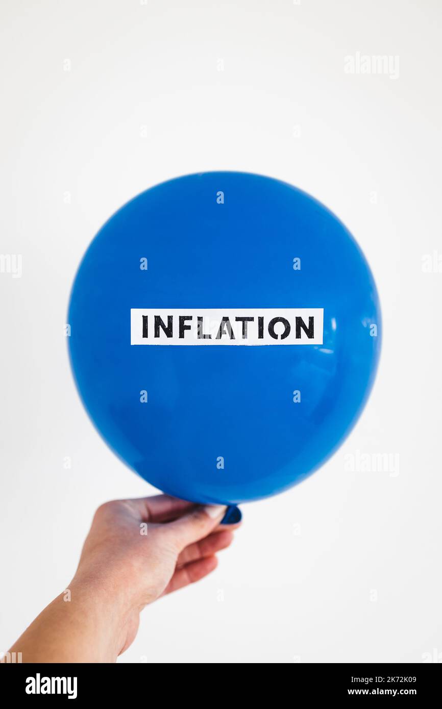 inflation text on top of big inflated balloon, funny conceptual image ...