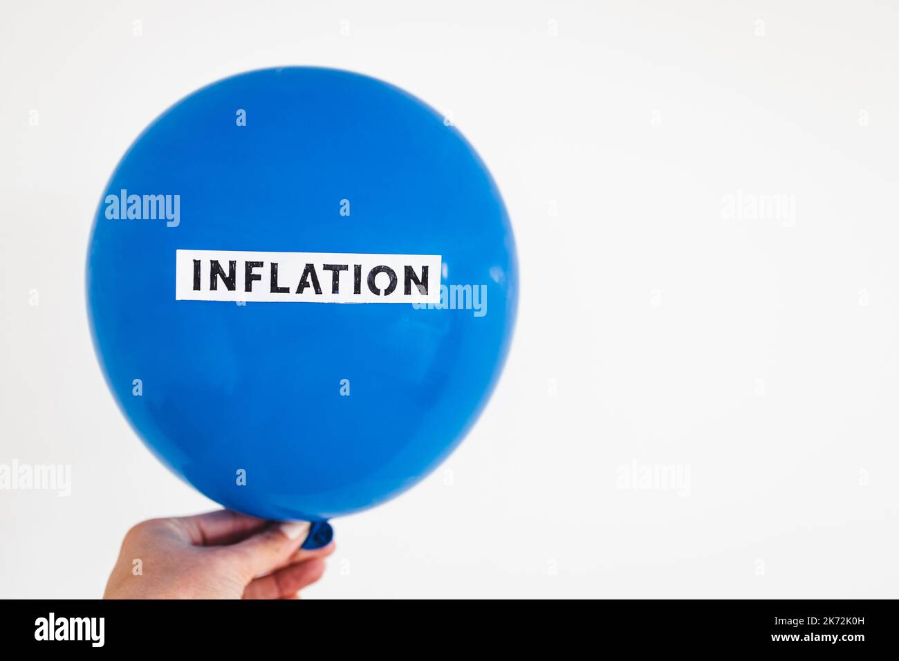 inflation text on top of big inflated balloon, funny conceptual image ...