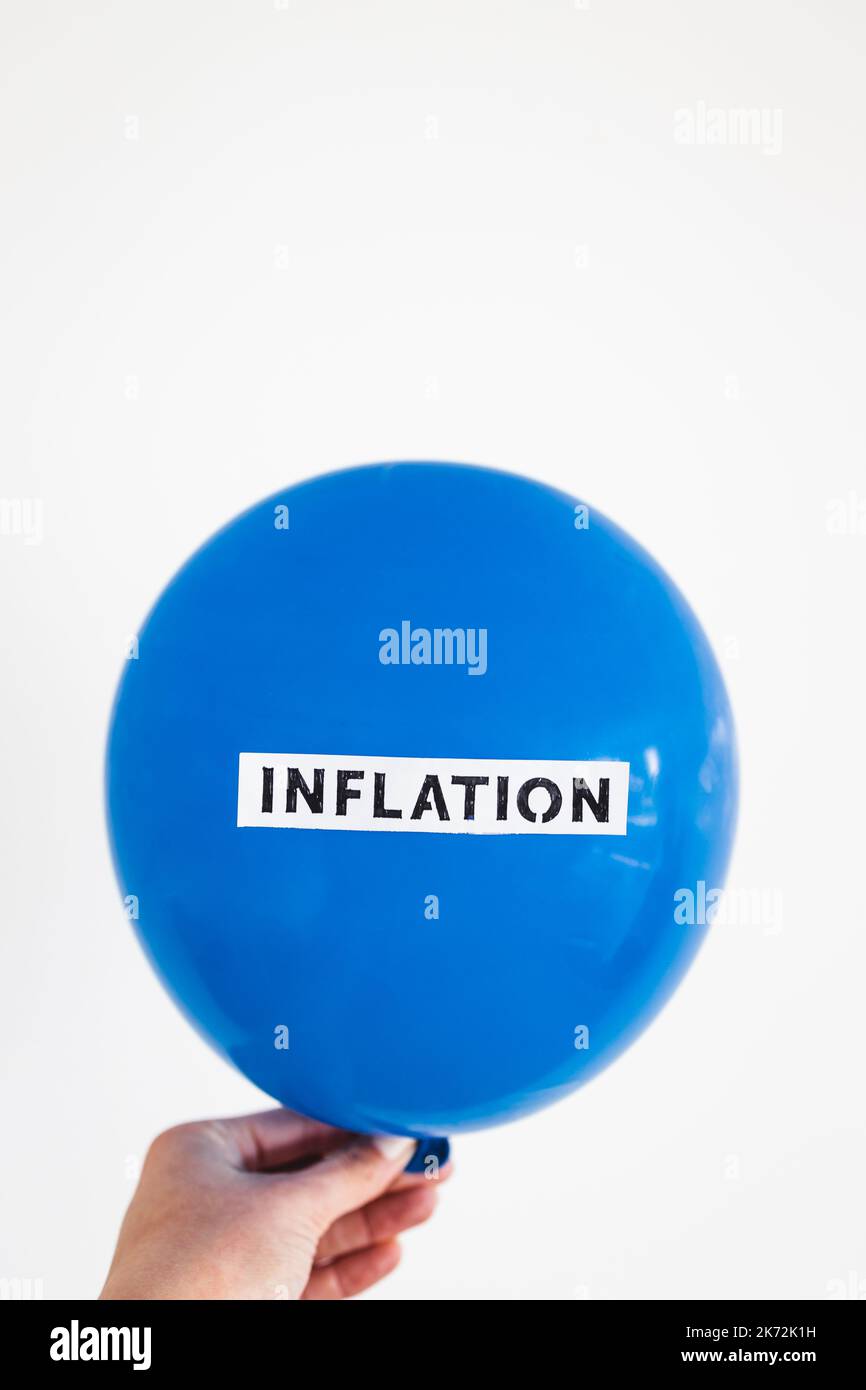 inflation text on top of big inflated balloon, funny conceptual image ...