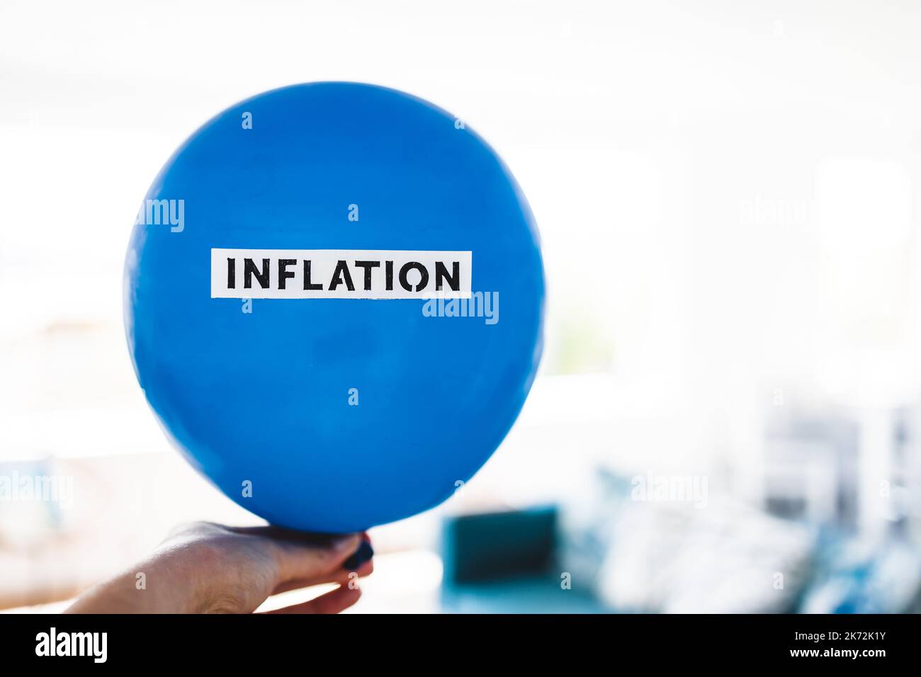 inflation text on top of big inflated balloon, funny conceptual image ...