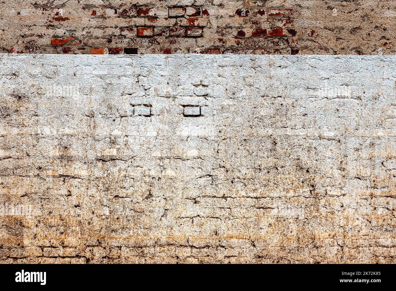 Texture of an old weathered damaged brick wall as background, ruined ...