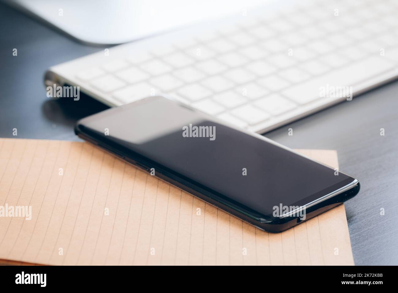 Smartphone and computer keyboard on office table close up Stock Photo ...