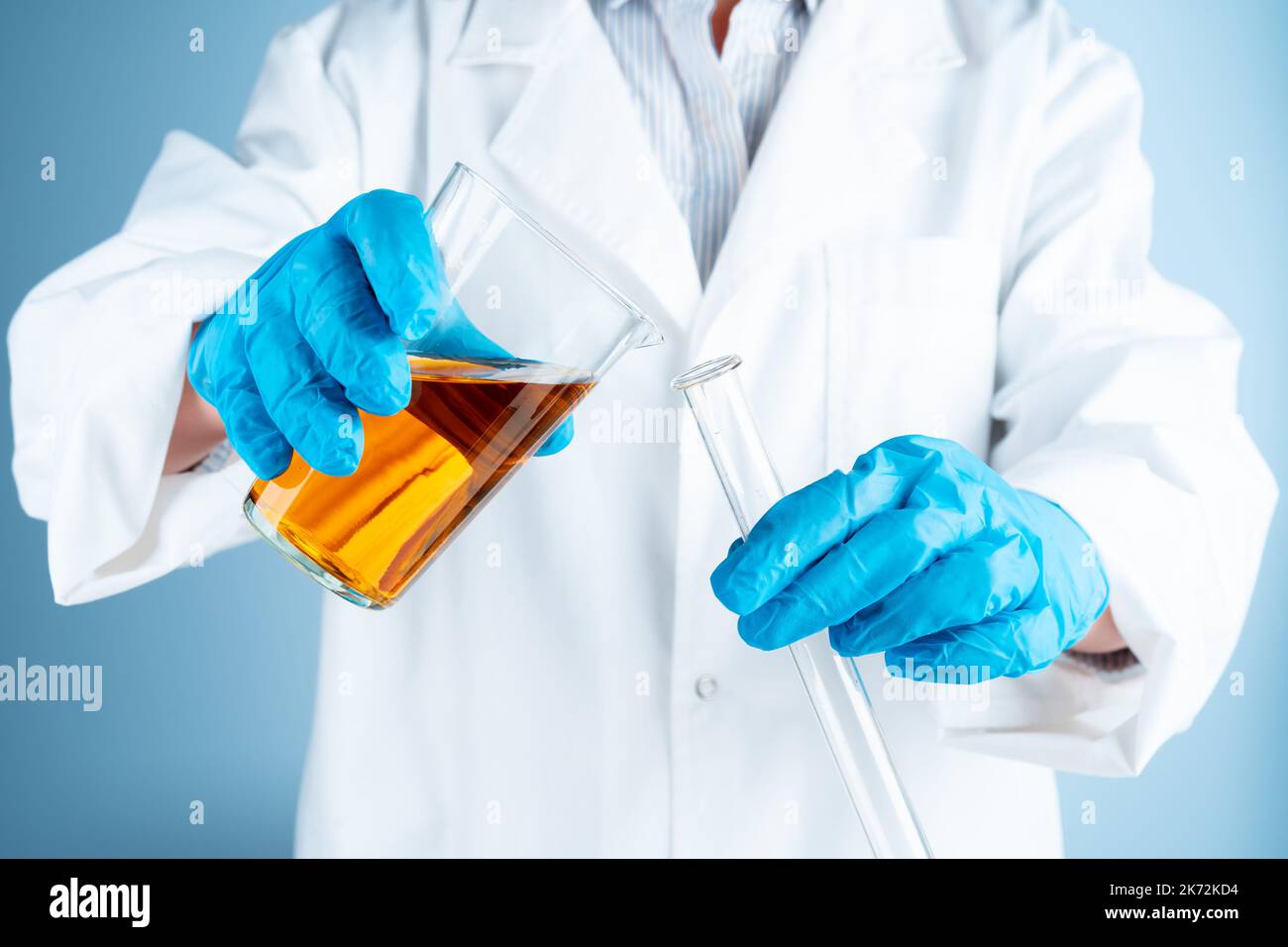 Young scientist with test tube making research in clinical laboratory ...