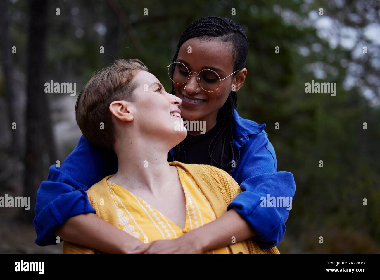 Female couple hugging outdoors Stock Photo - Alamy