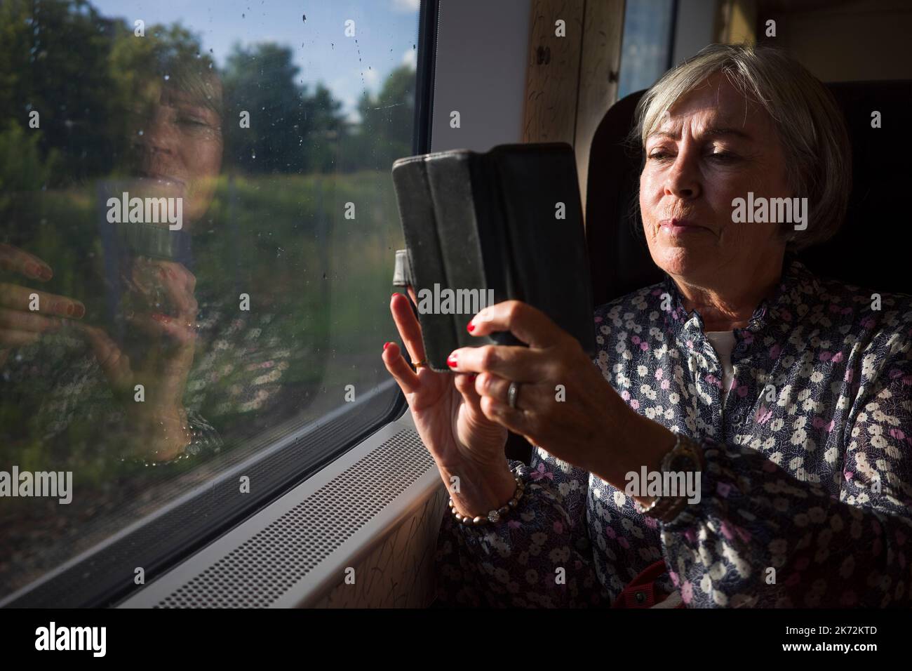 Mature woman looking through train hi-res stock photography and images ...