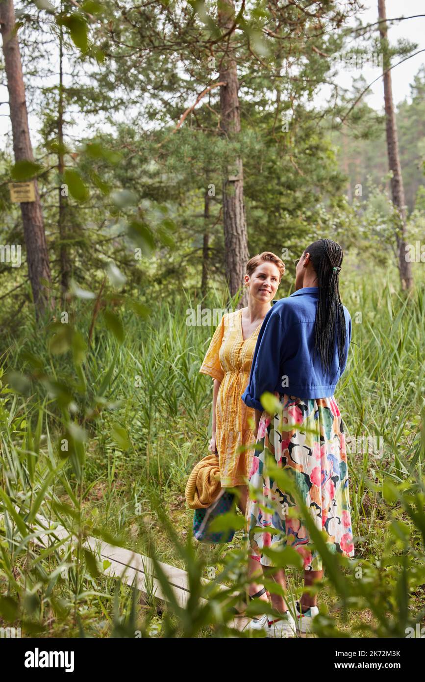 Female couple standing in forest Stock Photo - Alamy