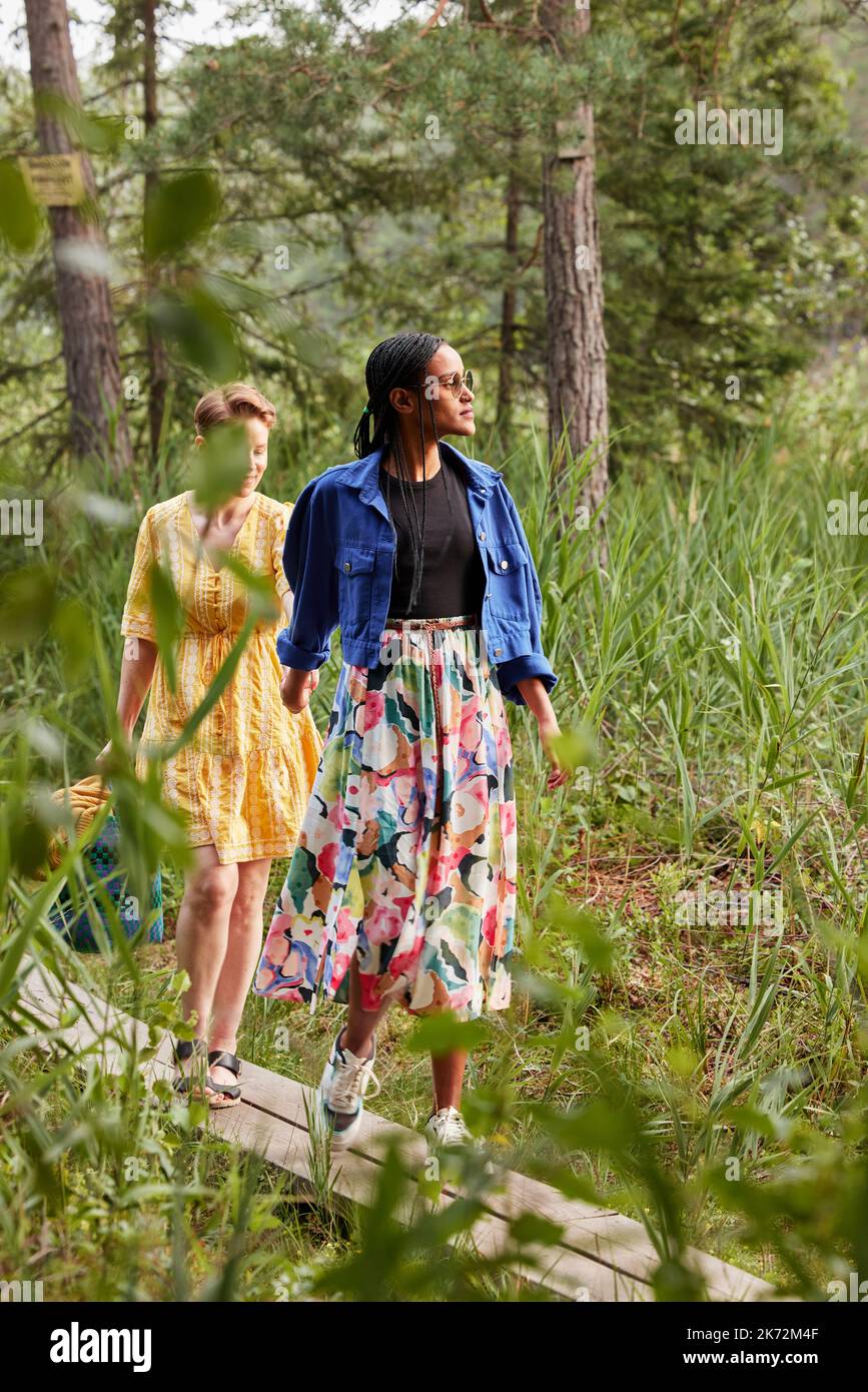 Female couple walking in forest Stock Photo - Alamy