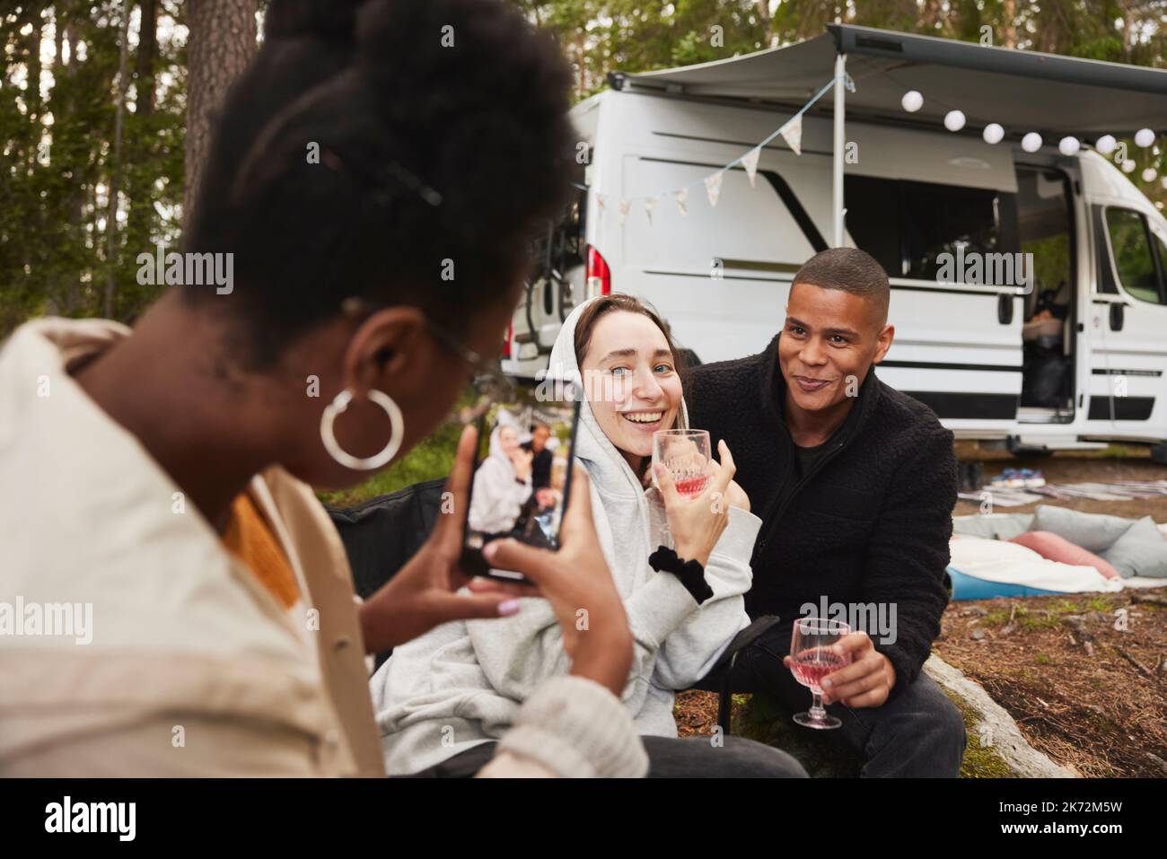 Friends having fun in front of camper van Stock Photo - Alamy