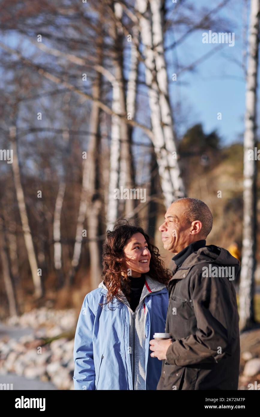 Couple standing and talking together Stock Photo - Alamy