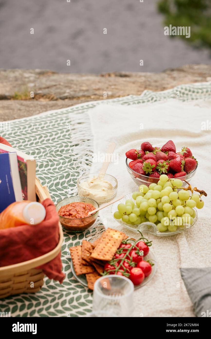 Fruit, vegetables, and crackers on picnic blanket Stock Photo - Alamy