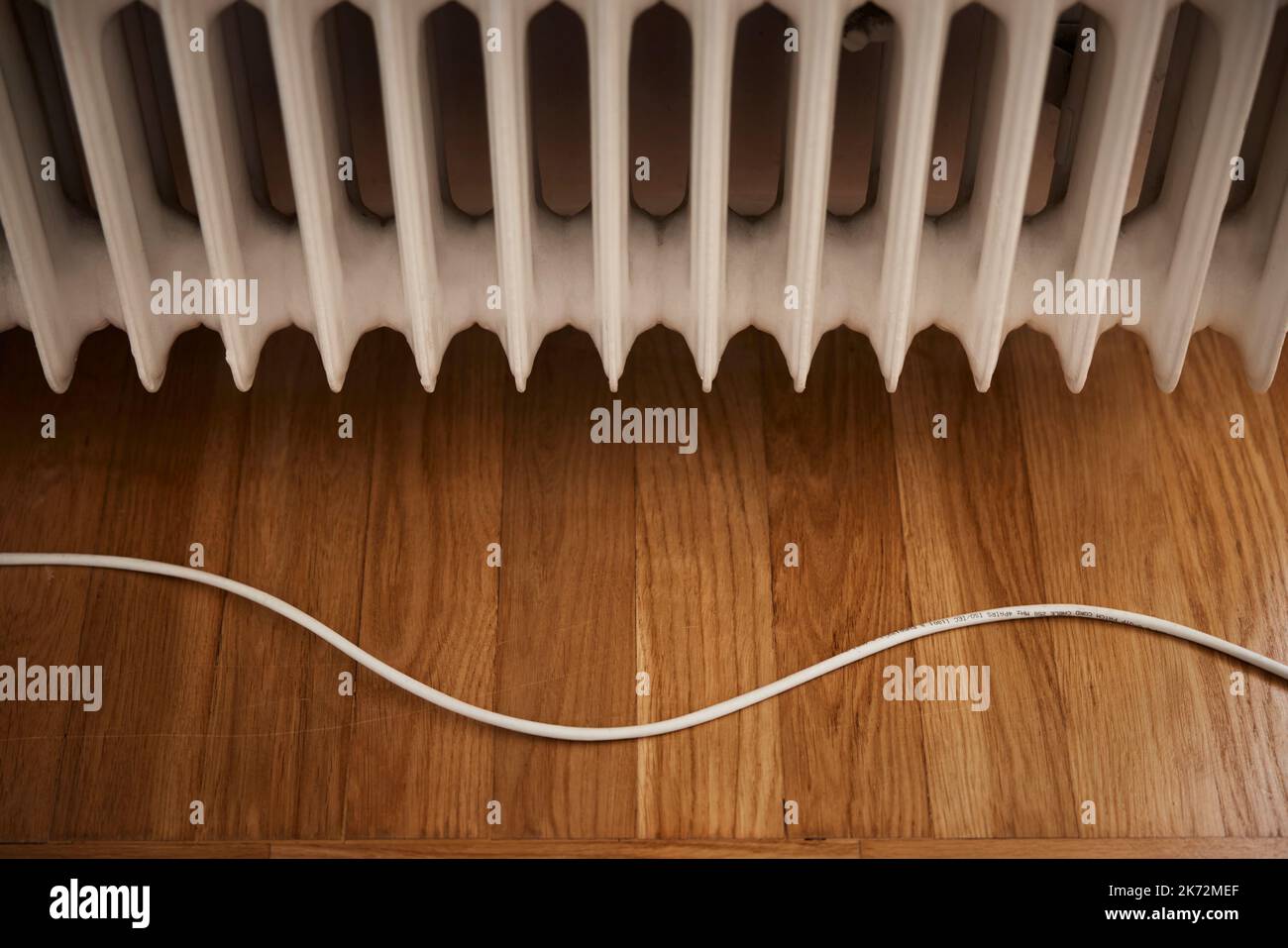Radiator and cable on floor Stock Photo - Alamy