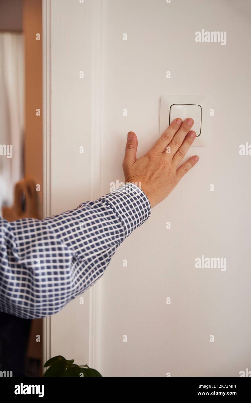 Man turning on light Stock Photo - Alamy