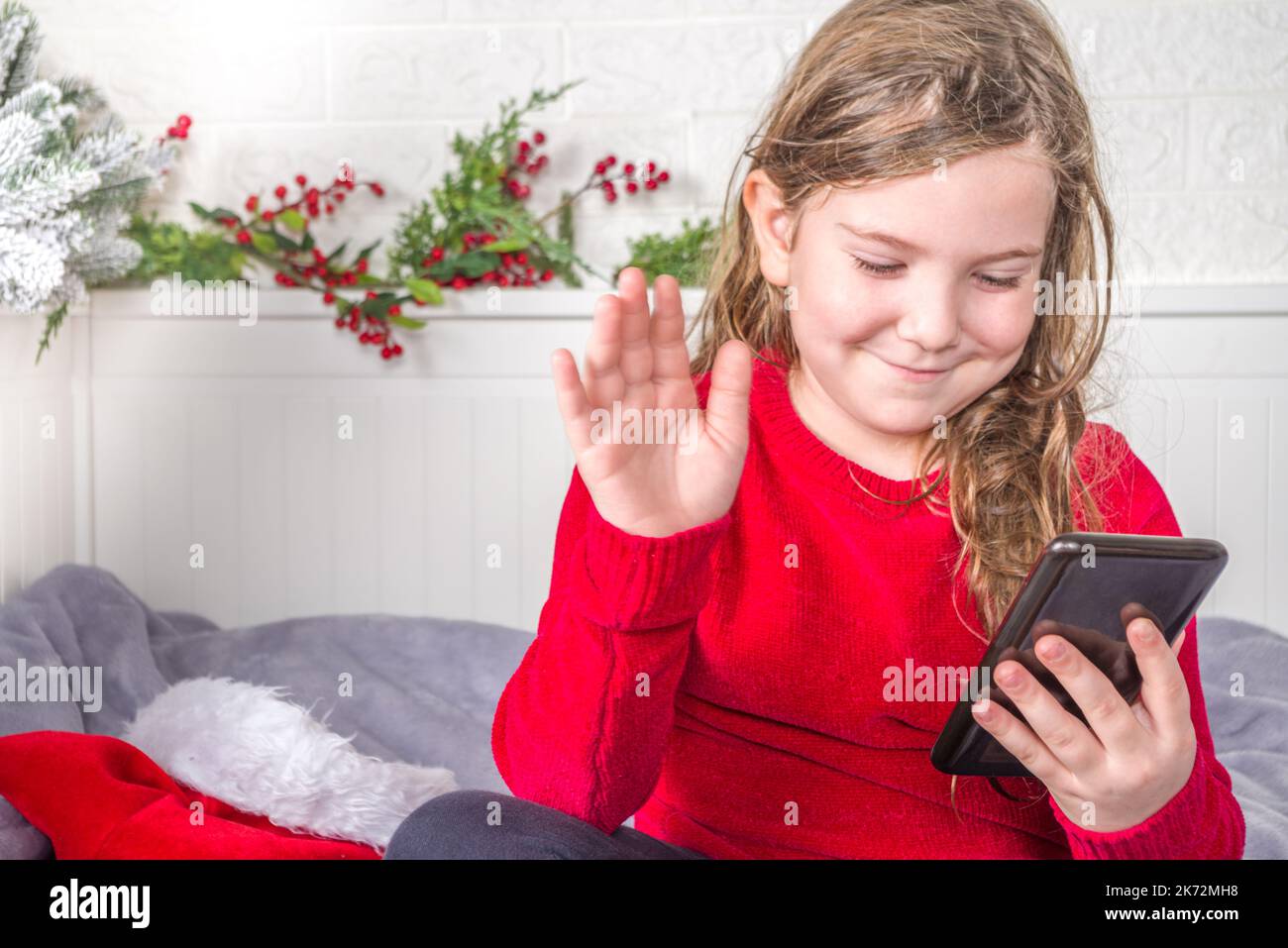 Close up photo of positive kid girl with santa claus hat and red ...