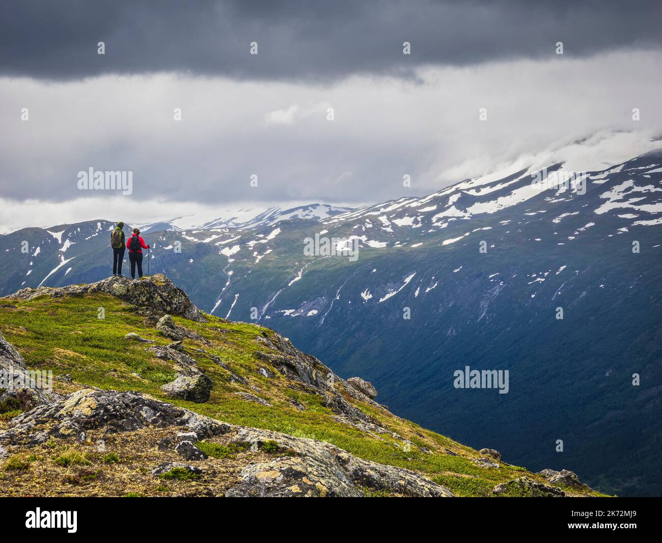 Hikers looking at mountain view Stock Photo - Alamy