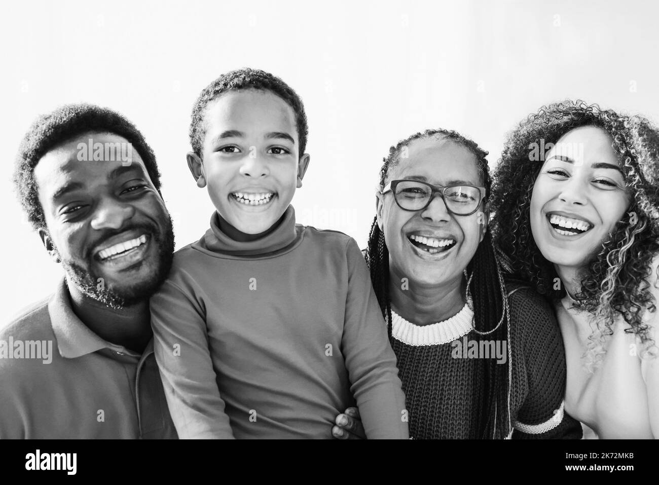 African family smiling on camera indoor at home - Soft focus on right ...