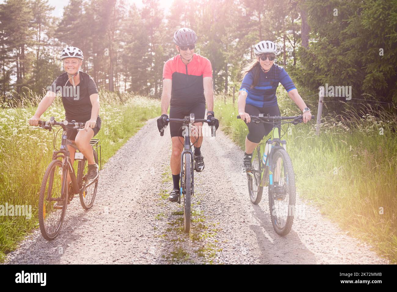 Smiling friends cycling together Stock Photo - Alamy