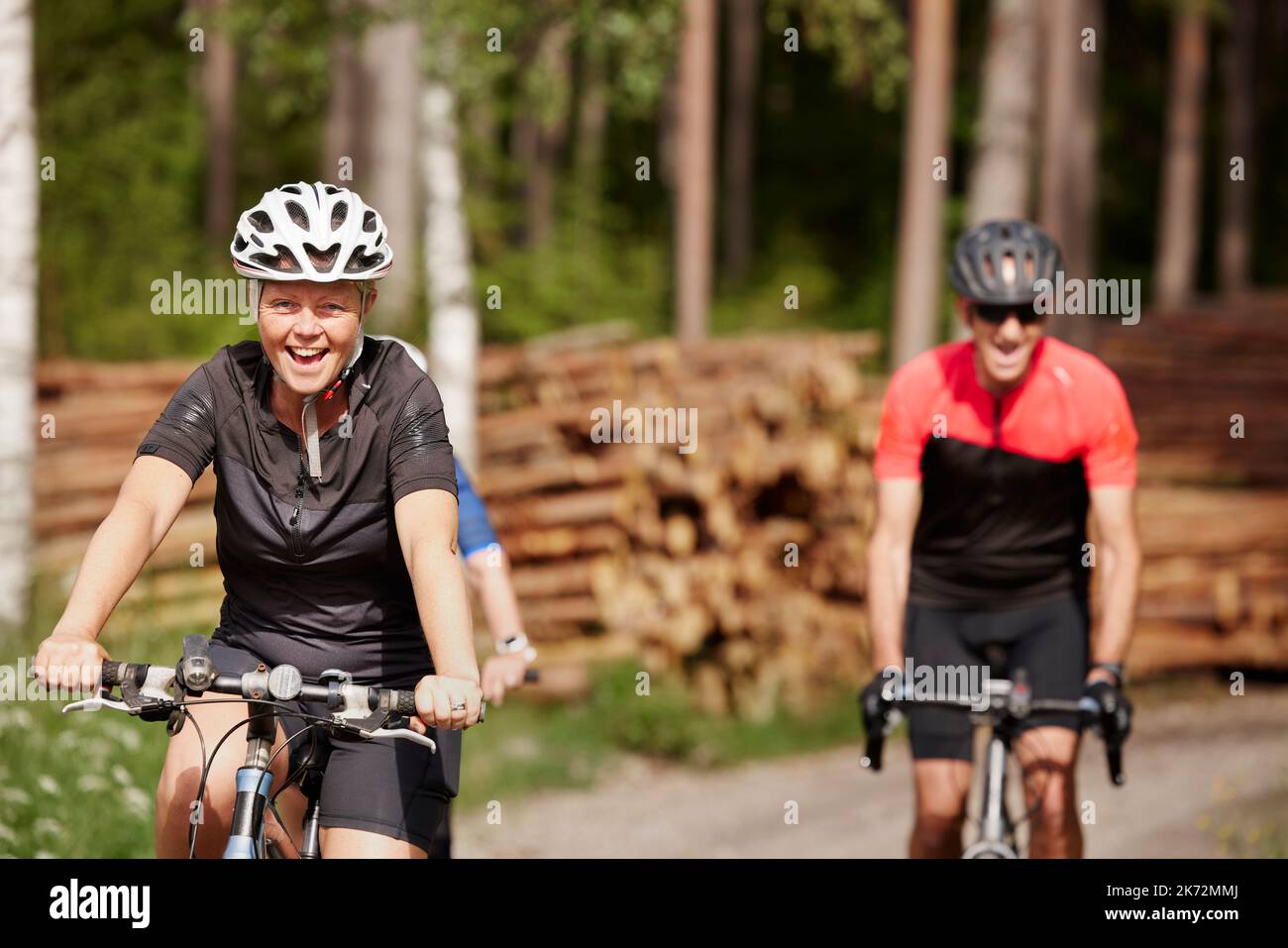 Smiling friends cycling together Stock Photo - Alamy