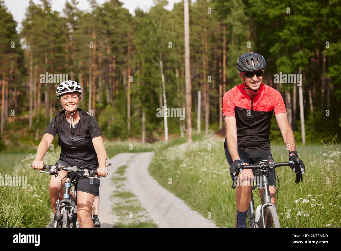 Smiling friends cycling together Stock Photo - Alamy