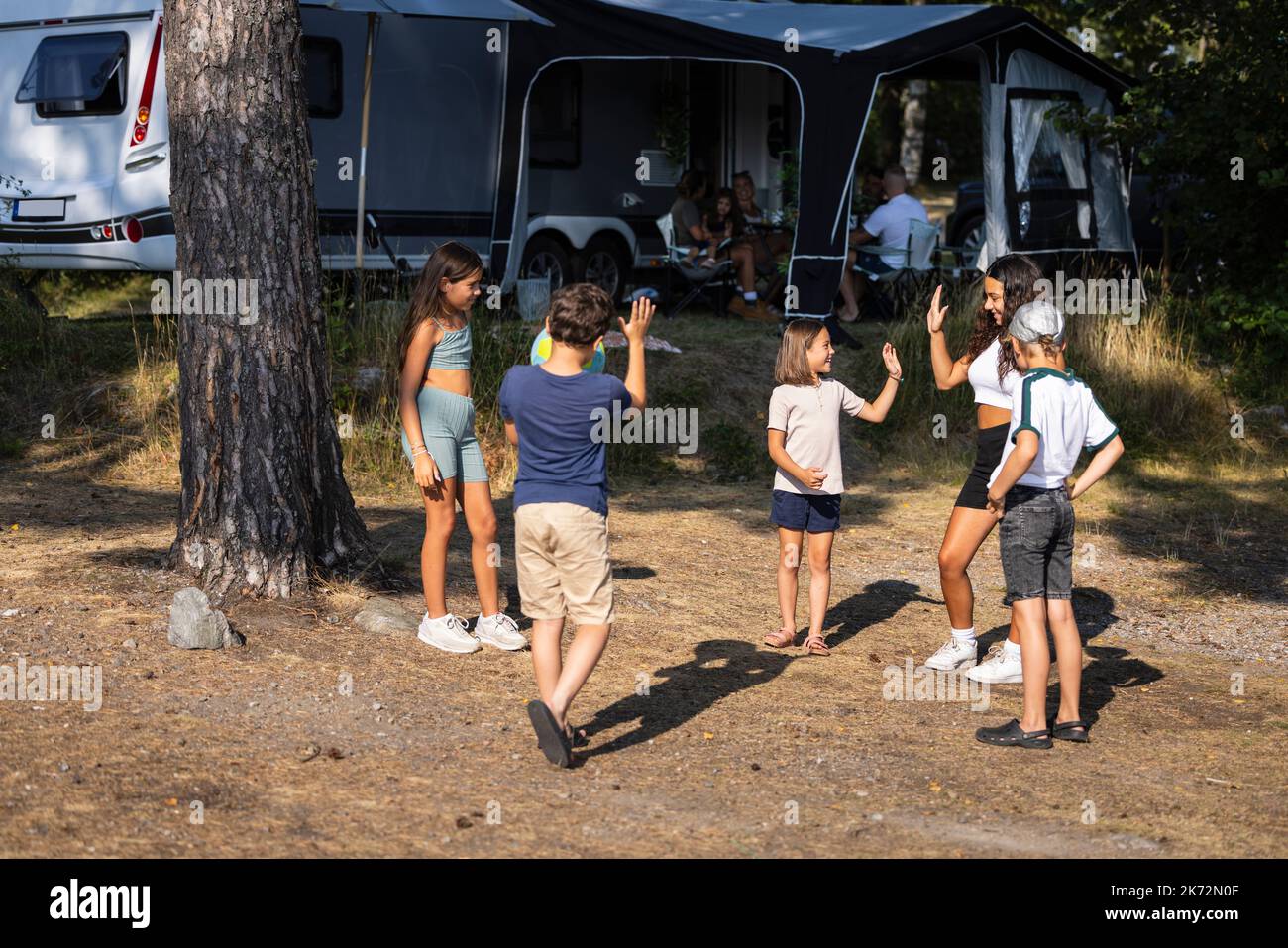 Children playing ball game on camping Stock Photo - Alamy