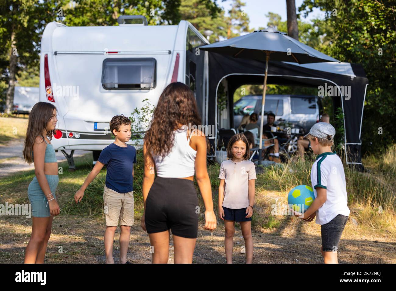 Children playing ball game on camping Stock Photo - Alamy