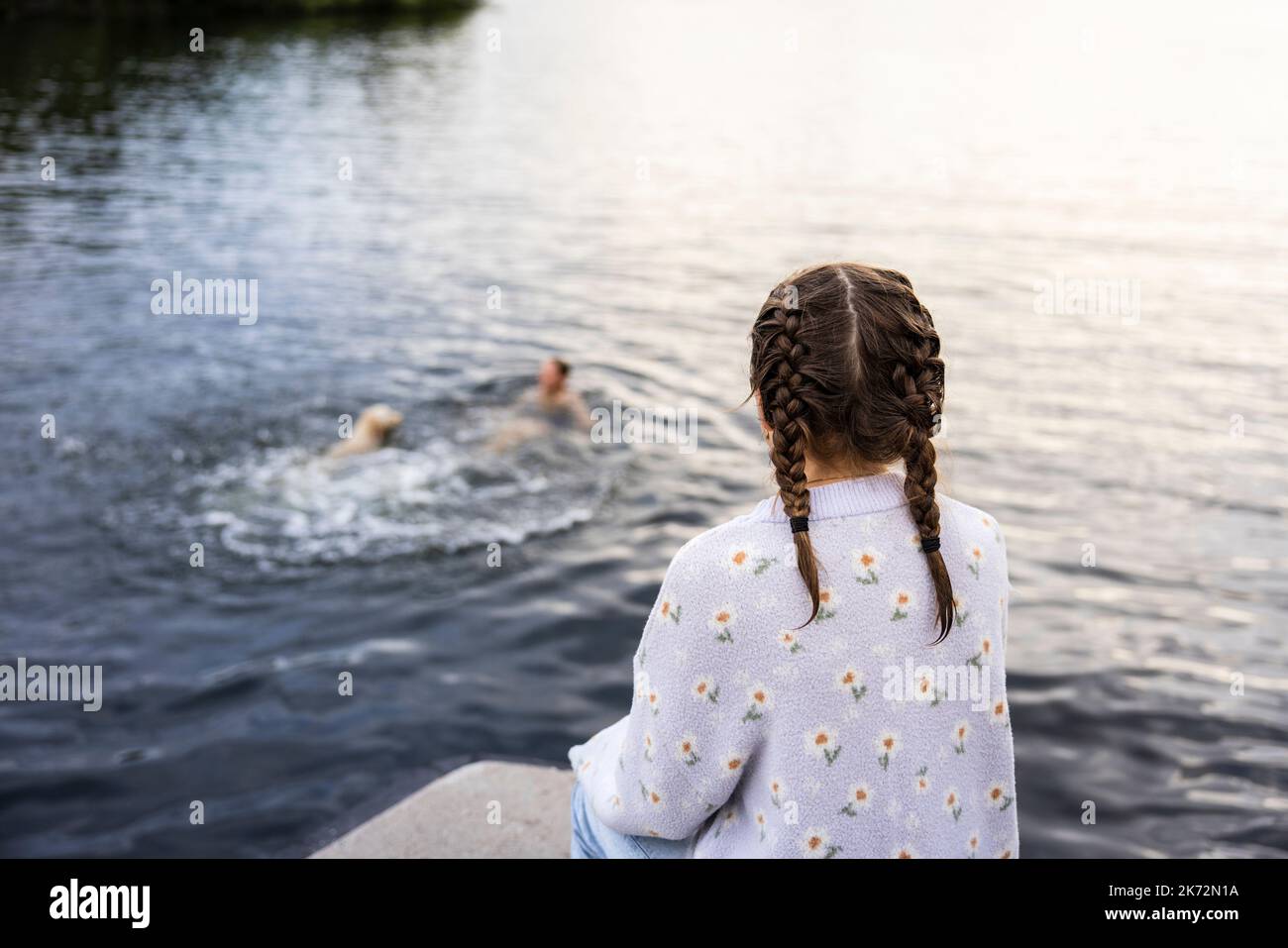 Girl looking at lake Stock Photo - Alamy