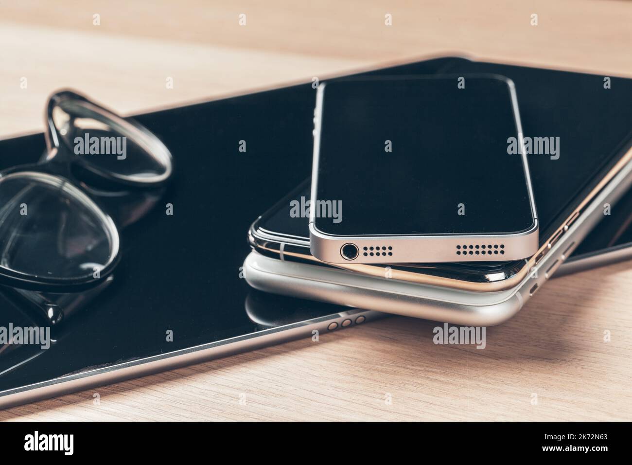 Digital tablet and mobile phone. Electronic devices on wooden table ...