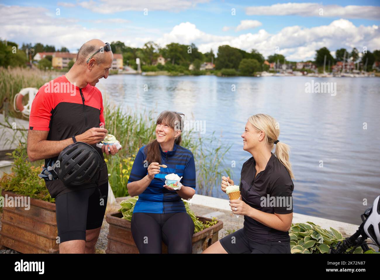 Friends having ice-cream at water Stock Photo - Alamy