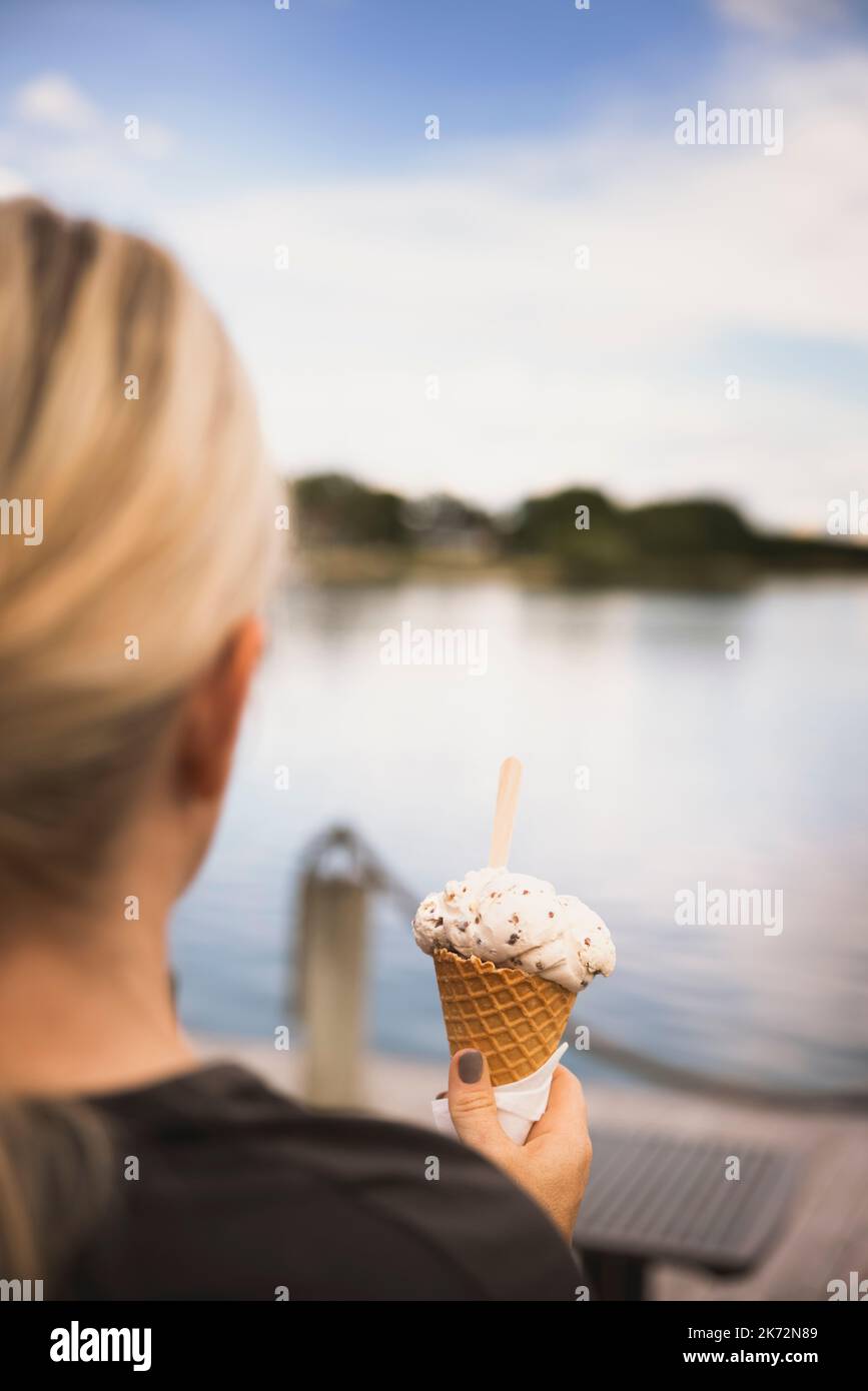 Woman's hand holding ice-cream cone Stock Photo - Alamy