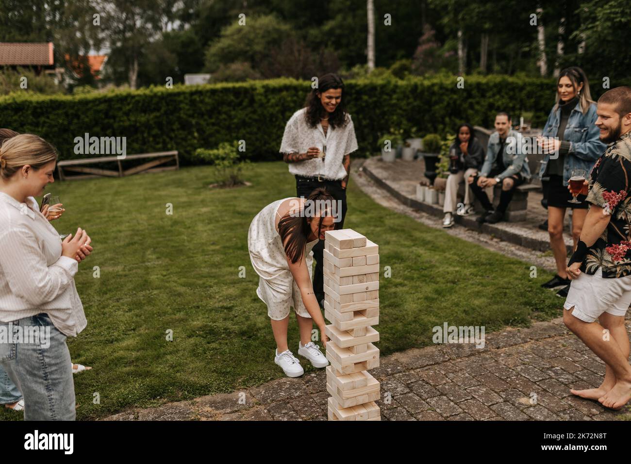 Friends playing jenga in garden Stock Photo - Alamy